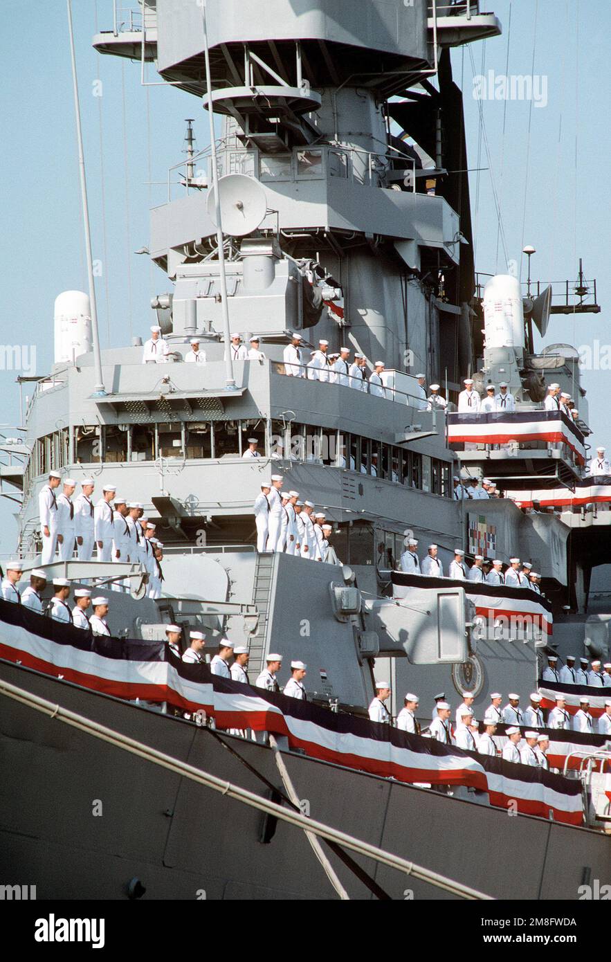 Crew members man the rails aboard the battleship USS WISCONSIN (BB-64 ...