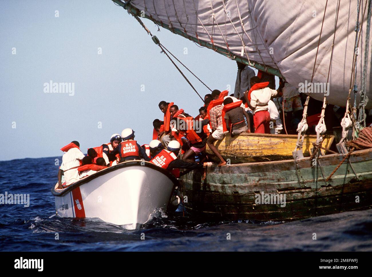 Haitian refugees board a Coast Guard boat. Nearly 15,000 Haitians have ...