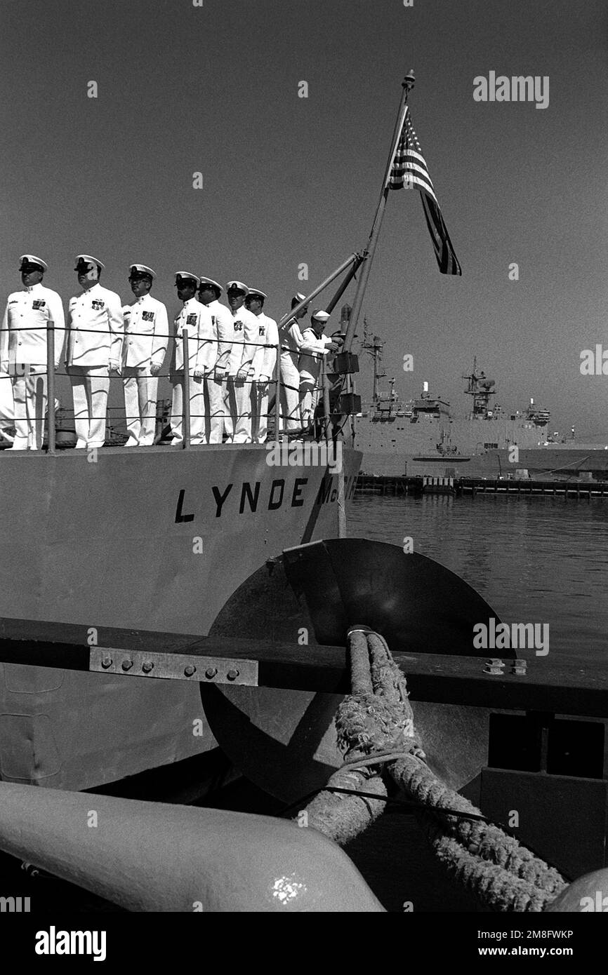 Officers stand at attention on the stern of the guided missile ...