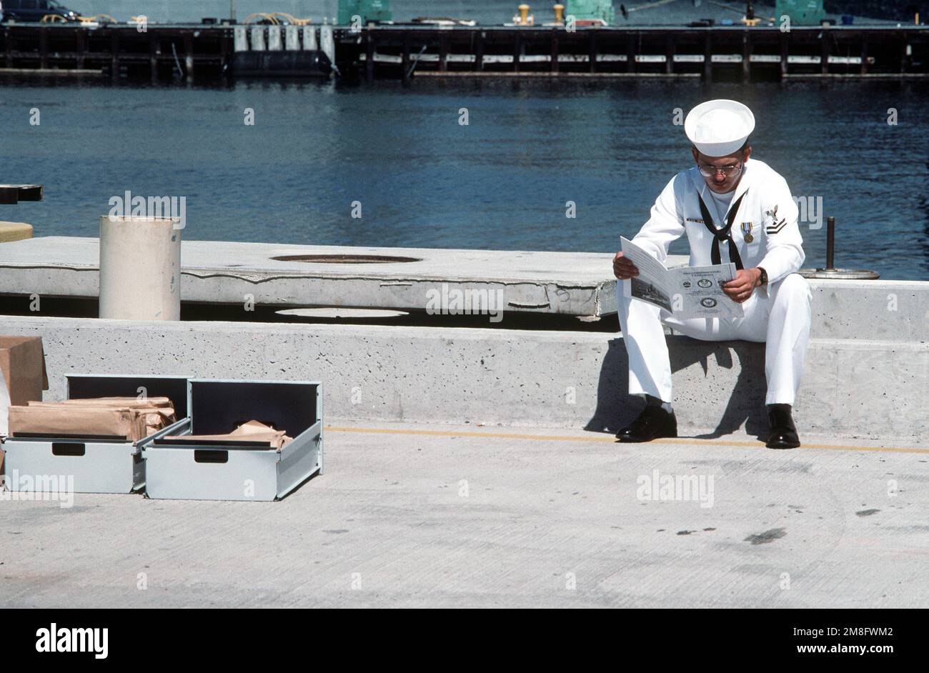 A petty officer reads through the program for decommissioning of the ...