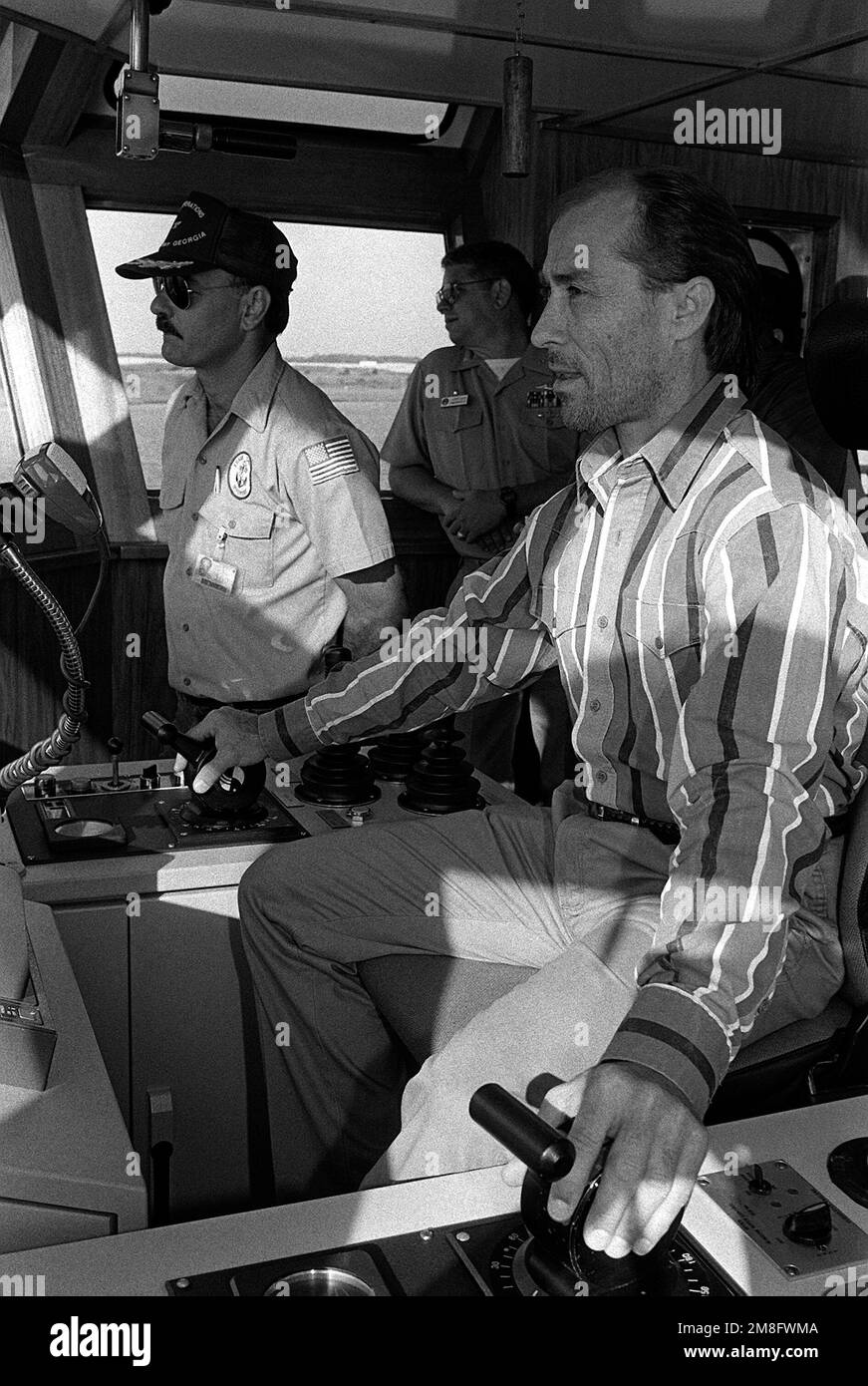 Country singer Lee Greenwood pilots a sub base C-tractor tug boat as ...