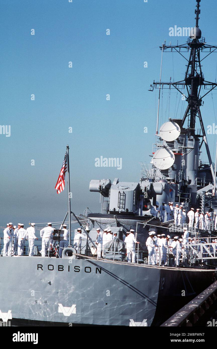 Sailors stand at ease aboard the guided missile destroyer USS ROBISON ...
