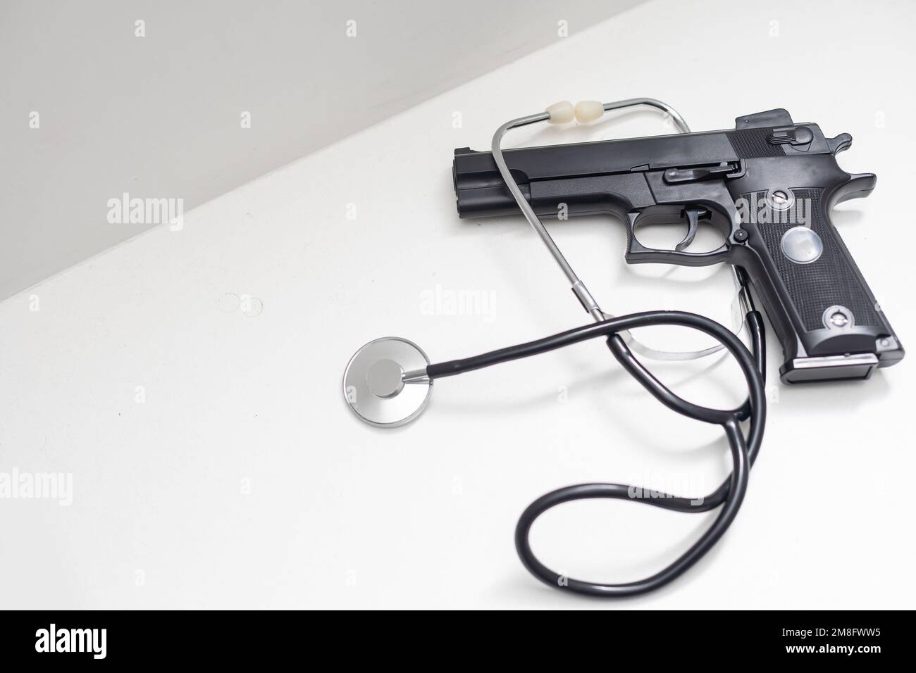 Doctor the murderer, stethoscope and gun Stock Photo - Alamy
