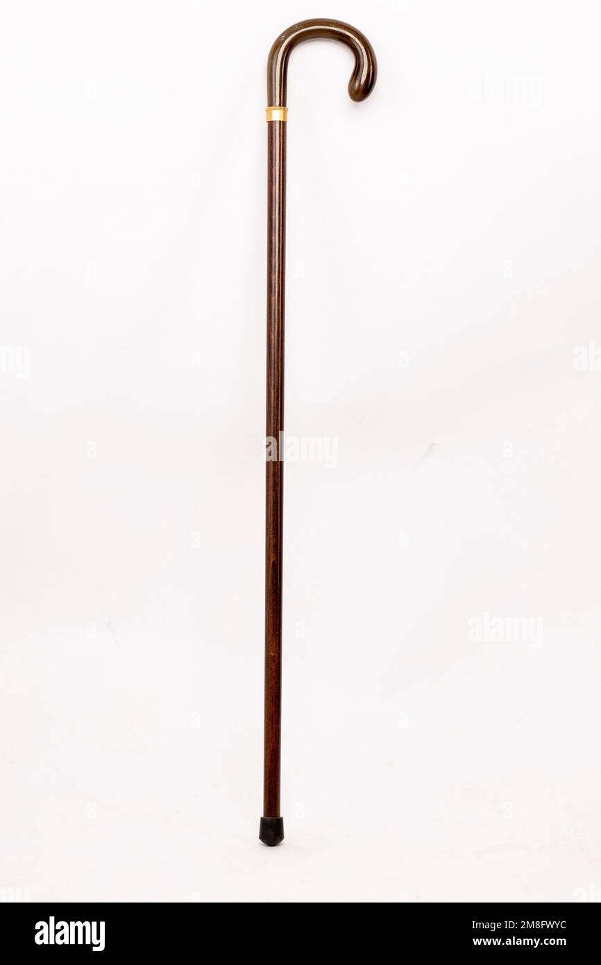A vertical shot of a cherry acacia wooden walking stick cane with ...