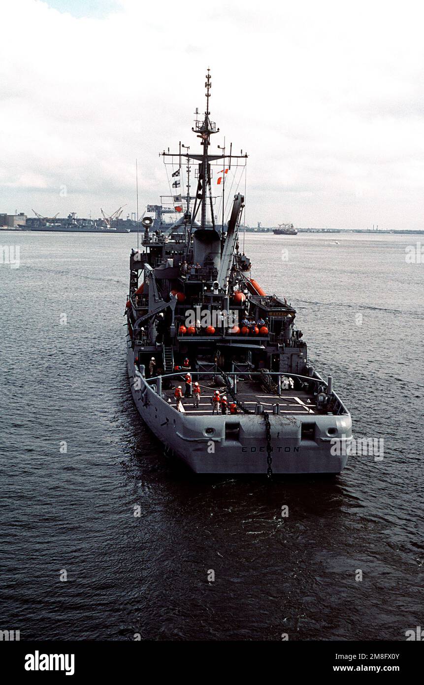 Crewmen aboard the salvage and rescue ship USS EDENTON (ATS-1) stand by ...