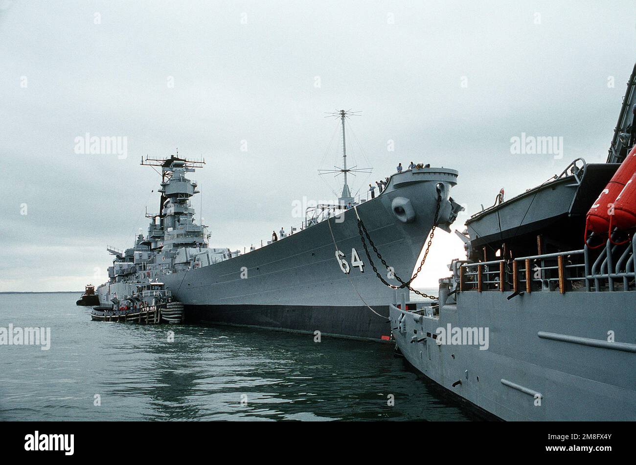 The large harbor tug WATHENA (YTB 825) maneuvers the battleship ...