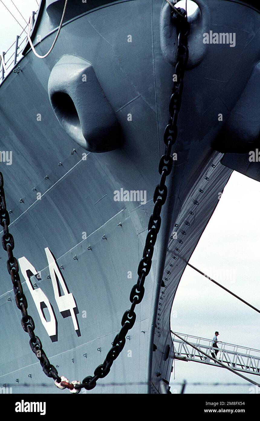 An anchor chain hangs from the bow of the battleship WISCONSIN (BB 64 ...