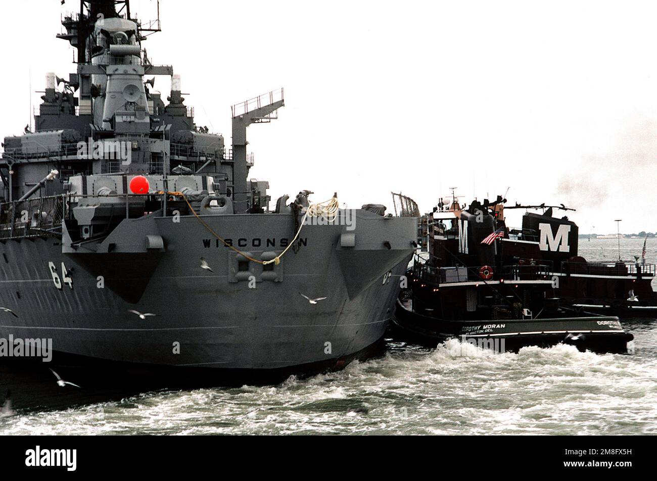 Two commercial harbor tugs maneuver the battleship USS WISCONSIN (BB 64 ...