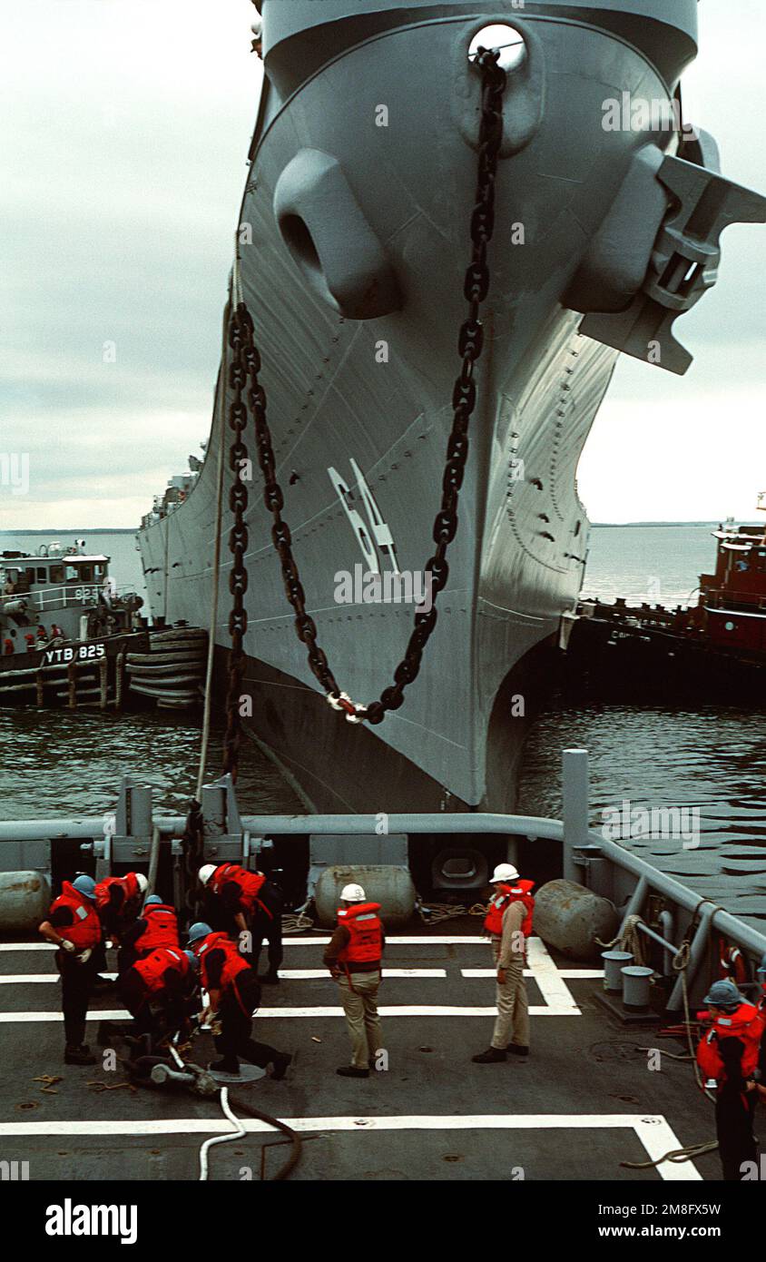 Crewmen on the stern of the salvage and rescue ship USS EDENTON (ATS-1 ...