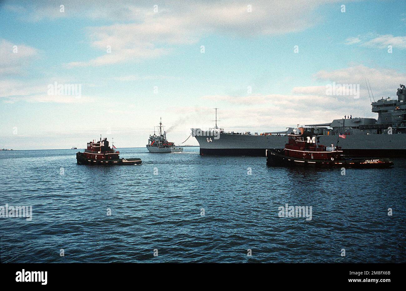 The salvage and rescue ship USS EDENTON (ATS-1) tows the battleship ...