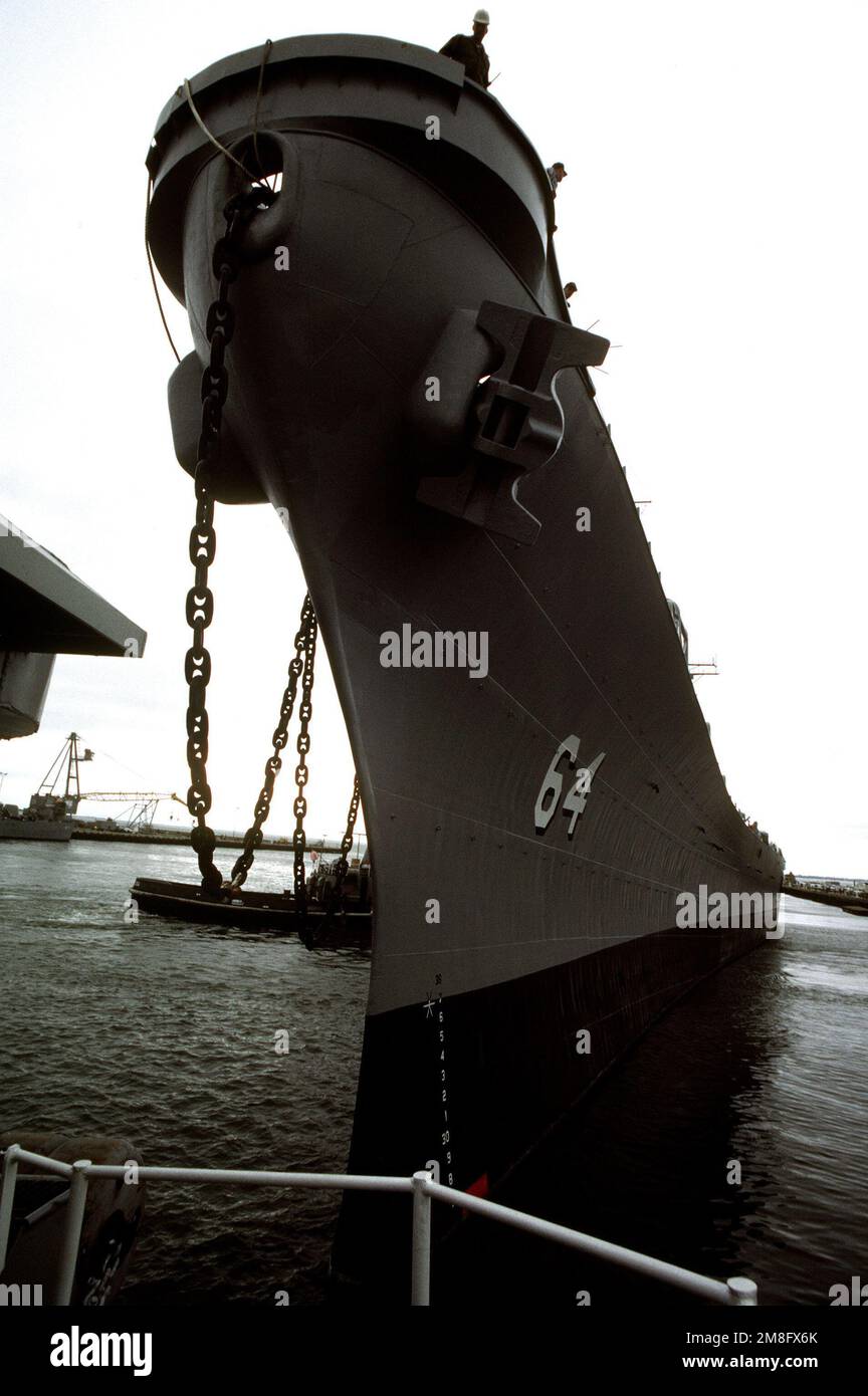 An anchor chain hangs from the bow of the battleship WISCONSIN (BB 64 ...