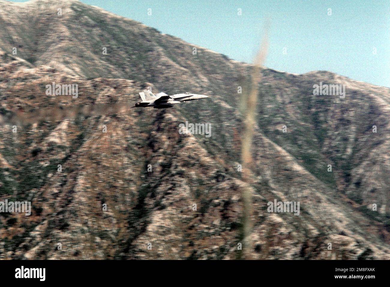 A strike Fighter Squadron 195 (VFA-195) F/A-18C Hornet aircraft passes ...