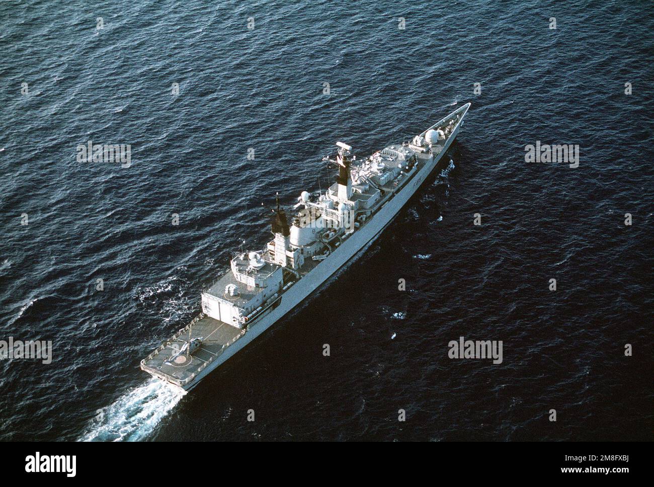 An aerial starboard quarter view of the British frigate HMS CUMBERLAND ...