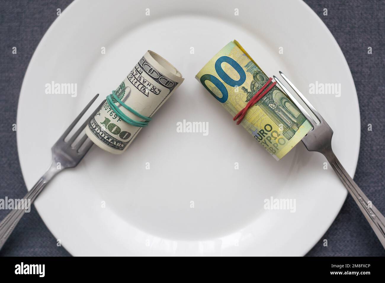 One american dollar bill on a white empty plate with utensils. On white ...