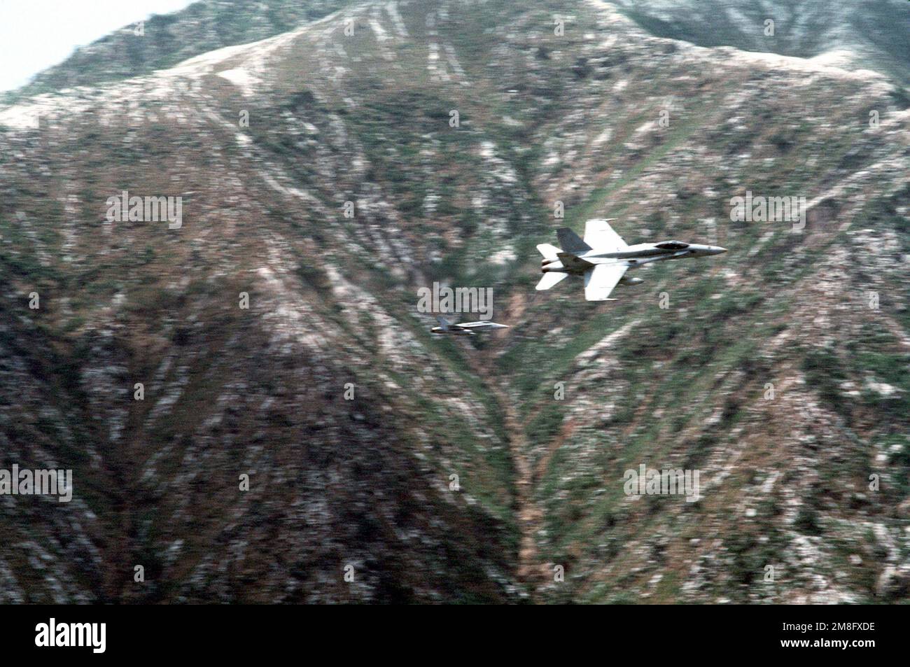 Two Strike Fighter Squadron 195 (VFA-195) F/A-18C Hornet aircraft pass ...