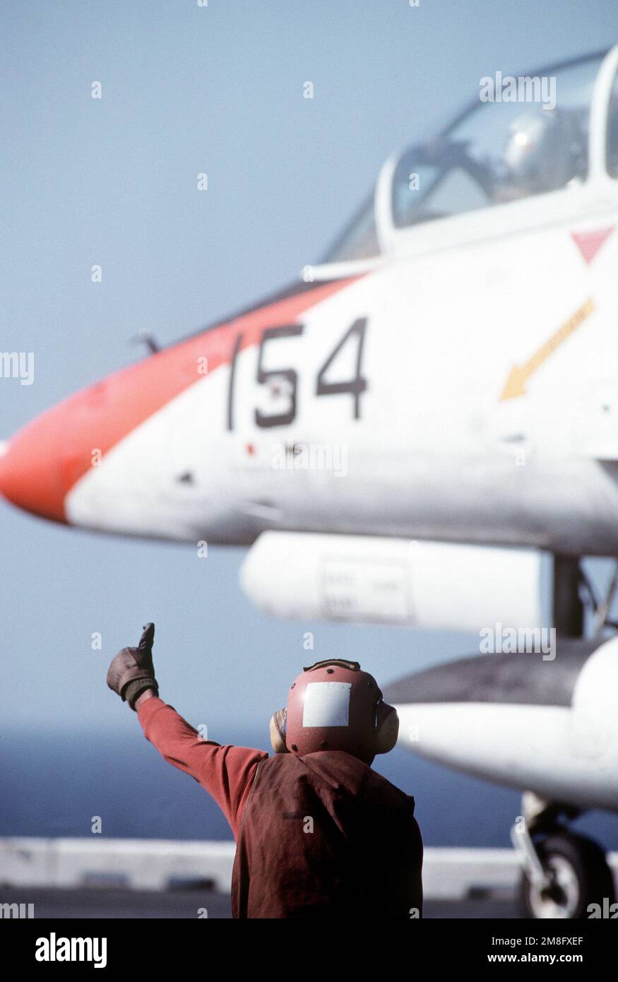 A plane captain signals "thumbs up" as a TA-4J Skyhawk aircraft taxis ...