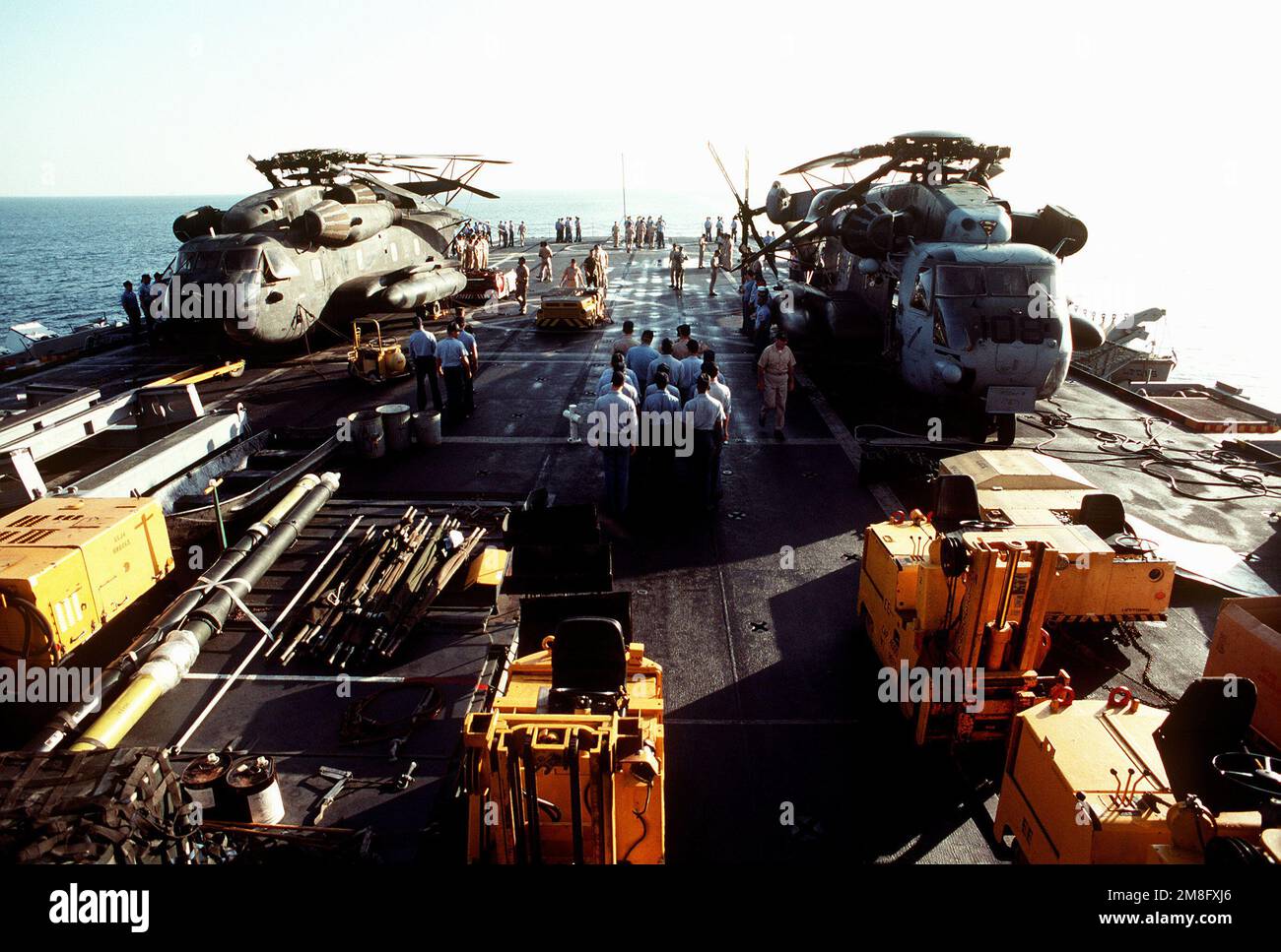 Sailors stand in formation with their respective divisions as quarters ...