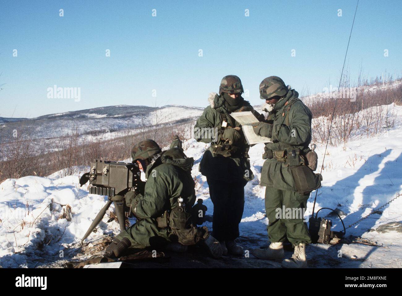 2LT Michael Reagan, center, and SSGT Thomas McNeal, right, check their ...