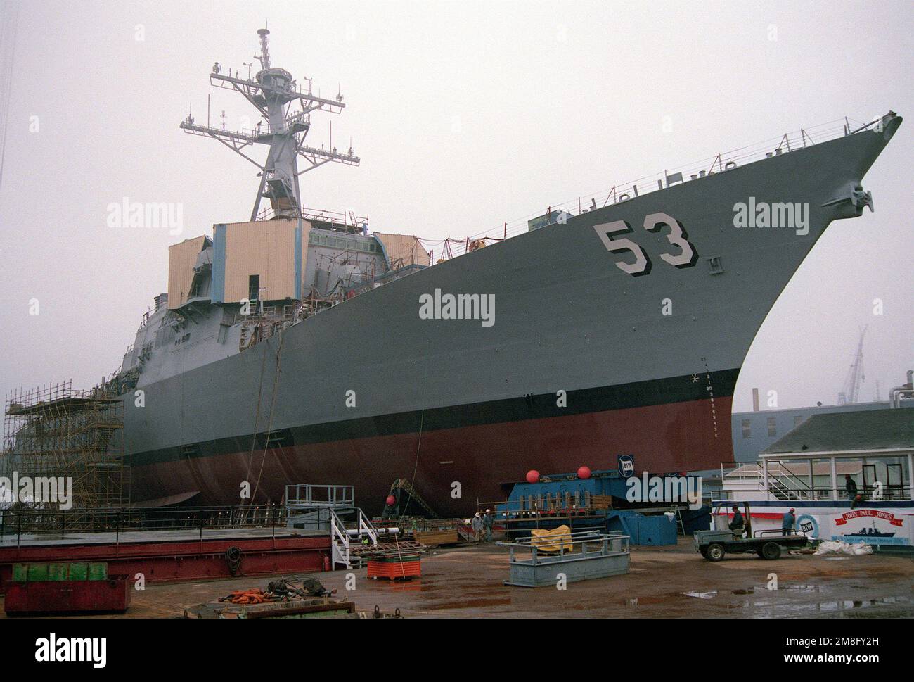 The guided missile destroyer JOHN PAUL JONES (DDG-53) stands in the way ...