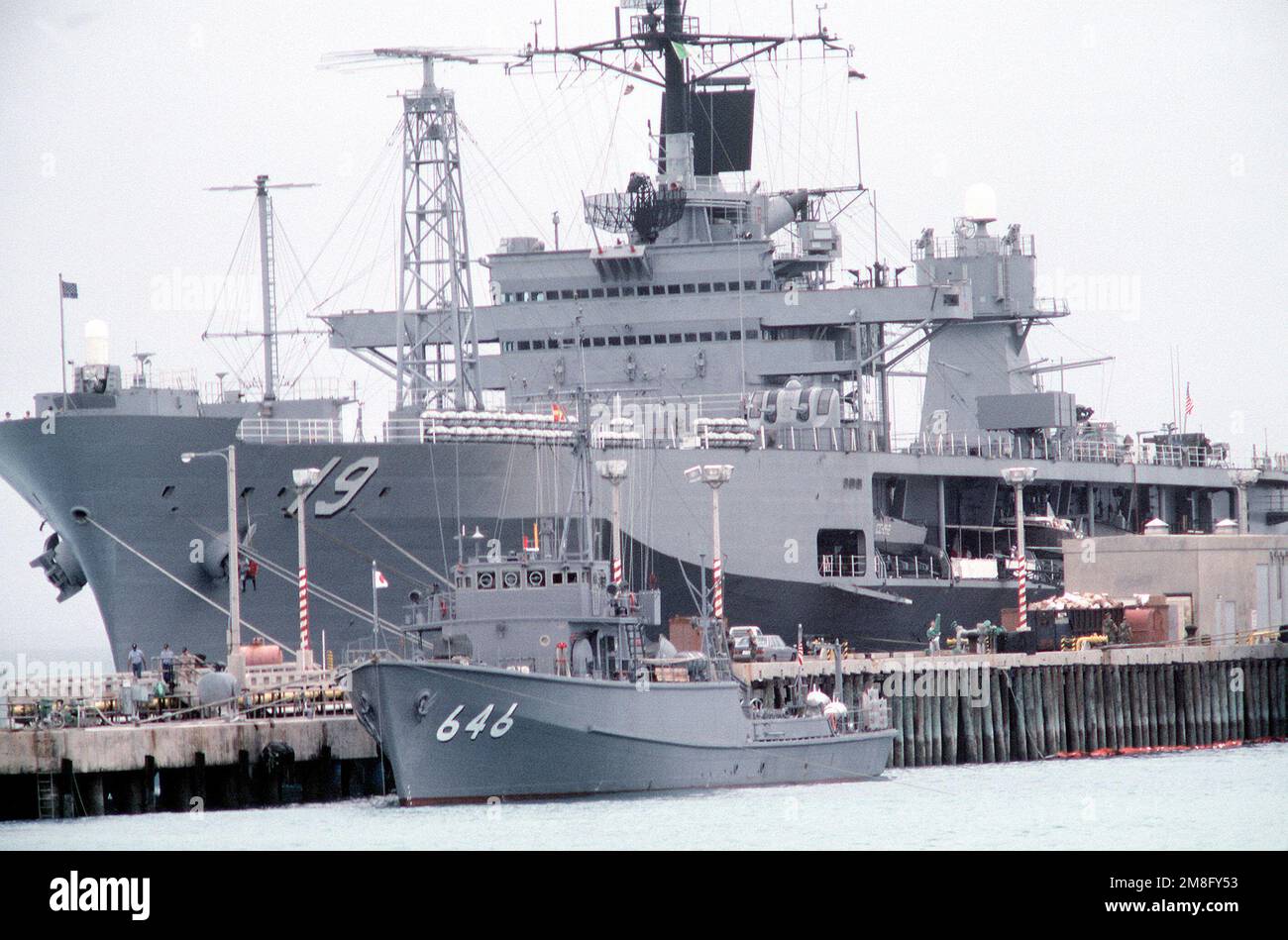 The amphibious command ship USS BLUE RIDGE (LCC-19), background, and ...