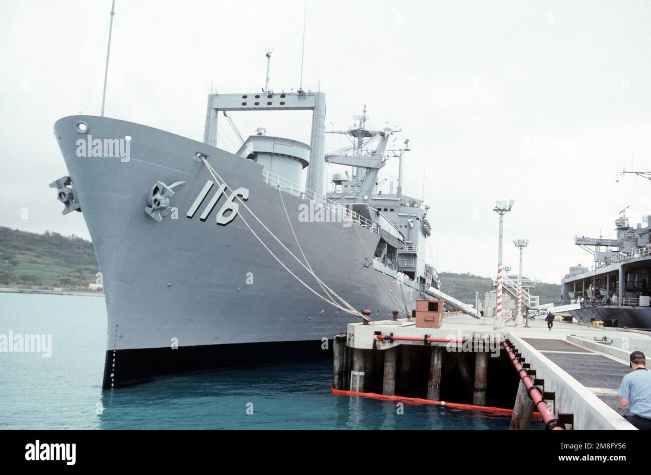 The amphibious cargo ship USS ST. LOUIS (LKA-116) is moored at a pier ...