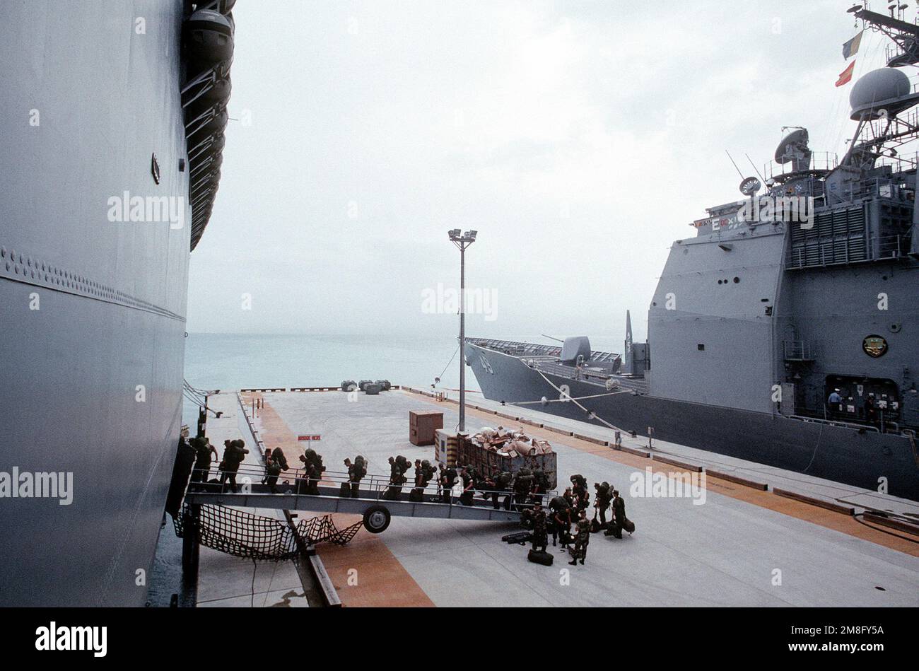 Marines board the amphibious transport dock USS DUBUQUE (LPD-8) in ...