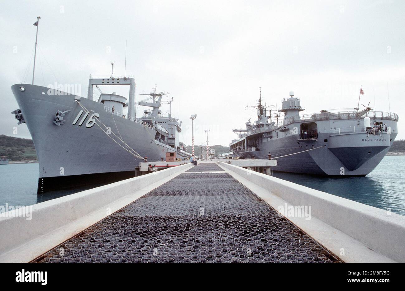 The amphibious cargo ship USS ST. LOUIS (LKA-116), left, and the ...