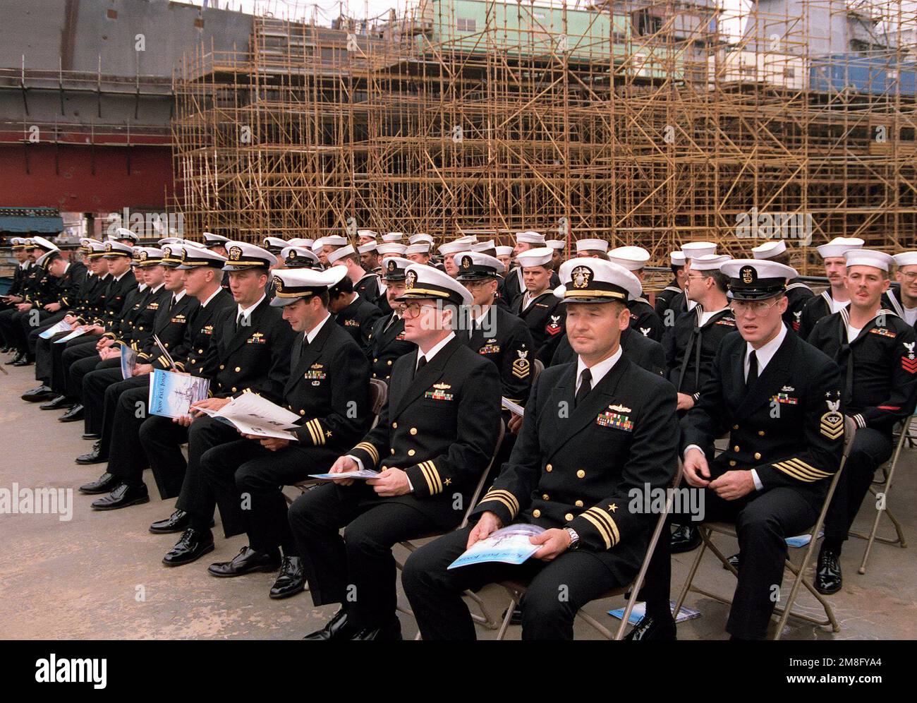 LCDR Mark H. Busby, front row, right, and the officers and enlisted men ...