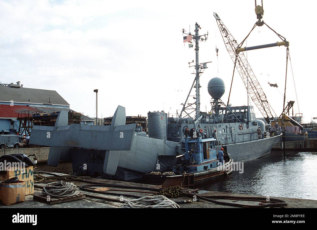 A tug maneuvers the patrol combatant missile hydrofoil USS AQUILA (PHM ...