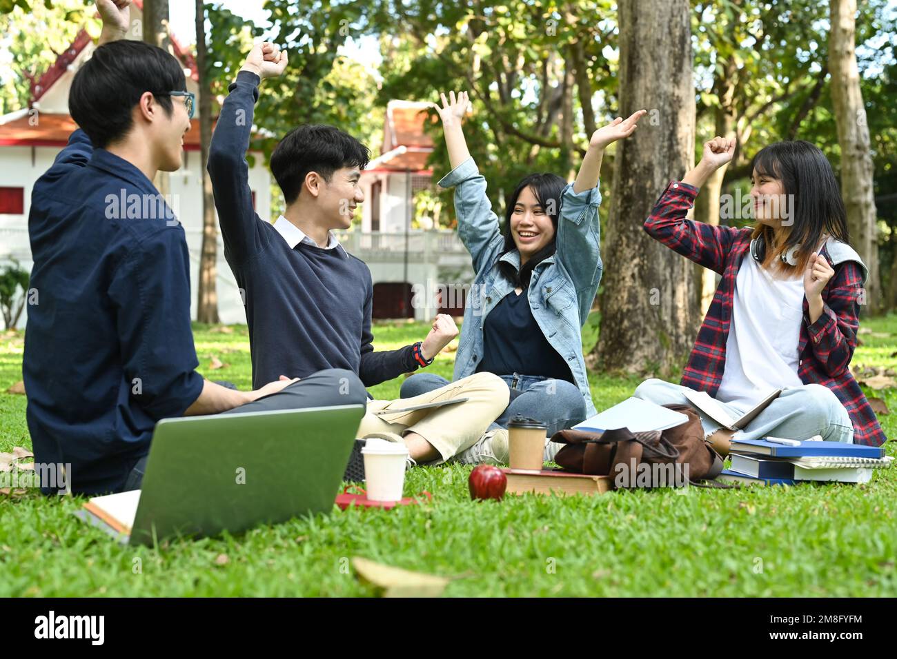 Cheerful female and male classmates having fun celebrating and laughing ...