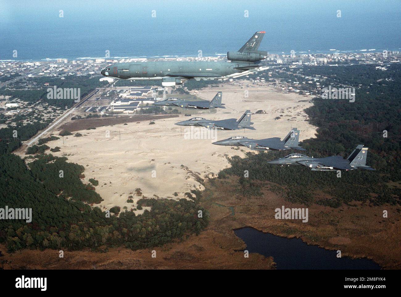 Four F-15E Eagle aircraft armed with AIM-9 Sidewinder missiles fly in ...