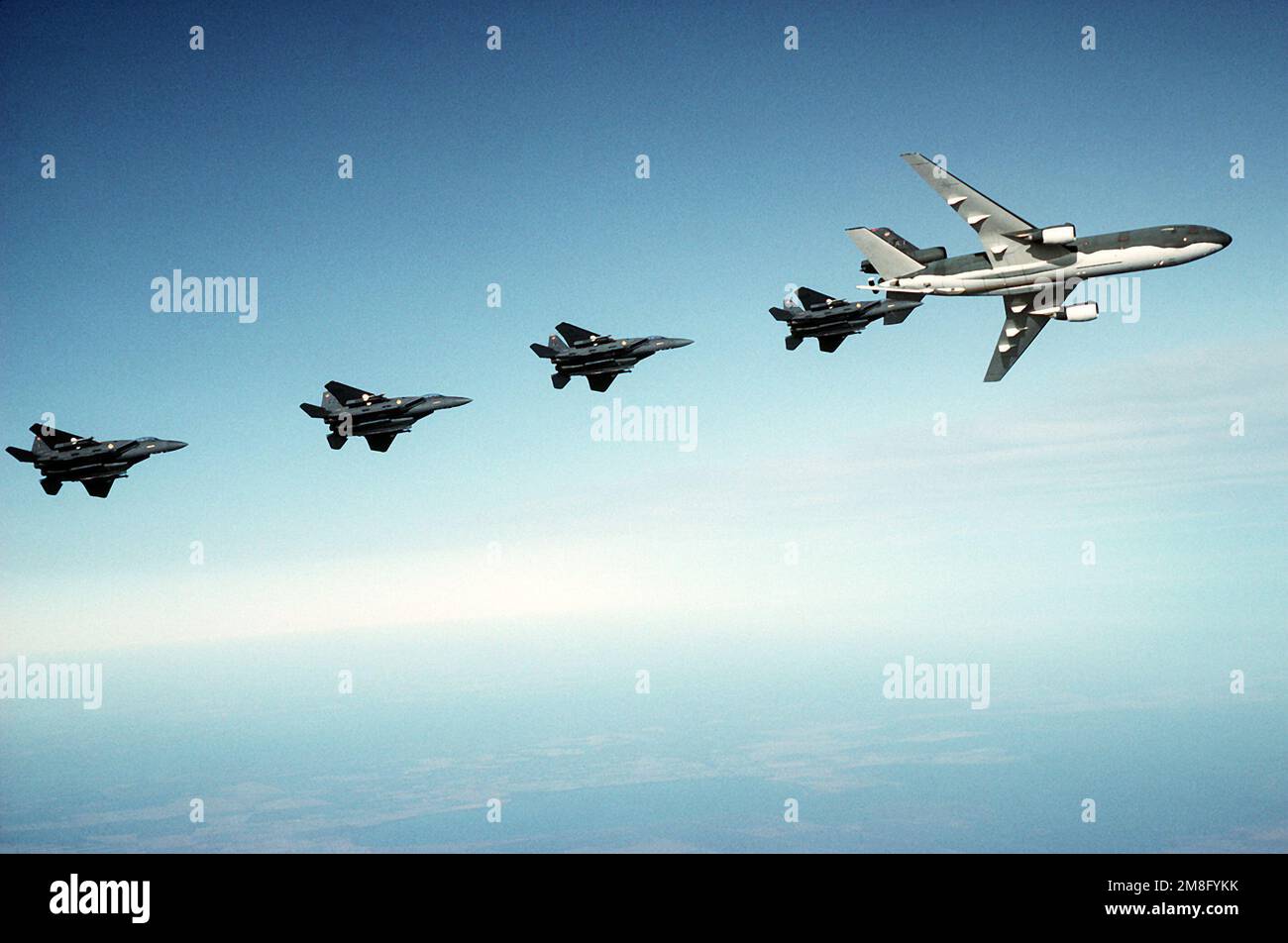Four F-15E Eagle aircraft armed with AIM -9 Sidewinder missiles line up ...