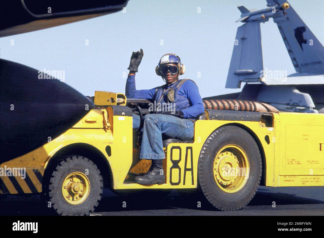 A member of the aircraft handling crew sits at the wheel of an MD-3A ...