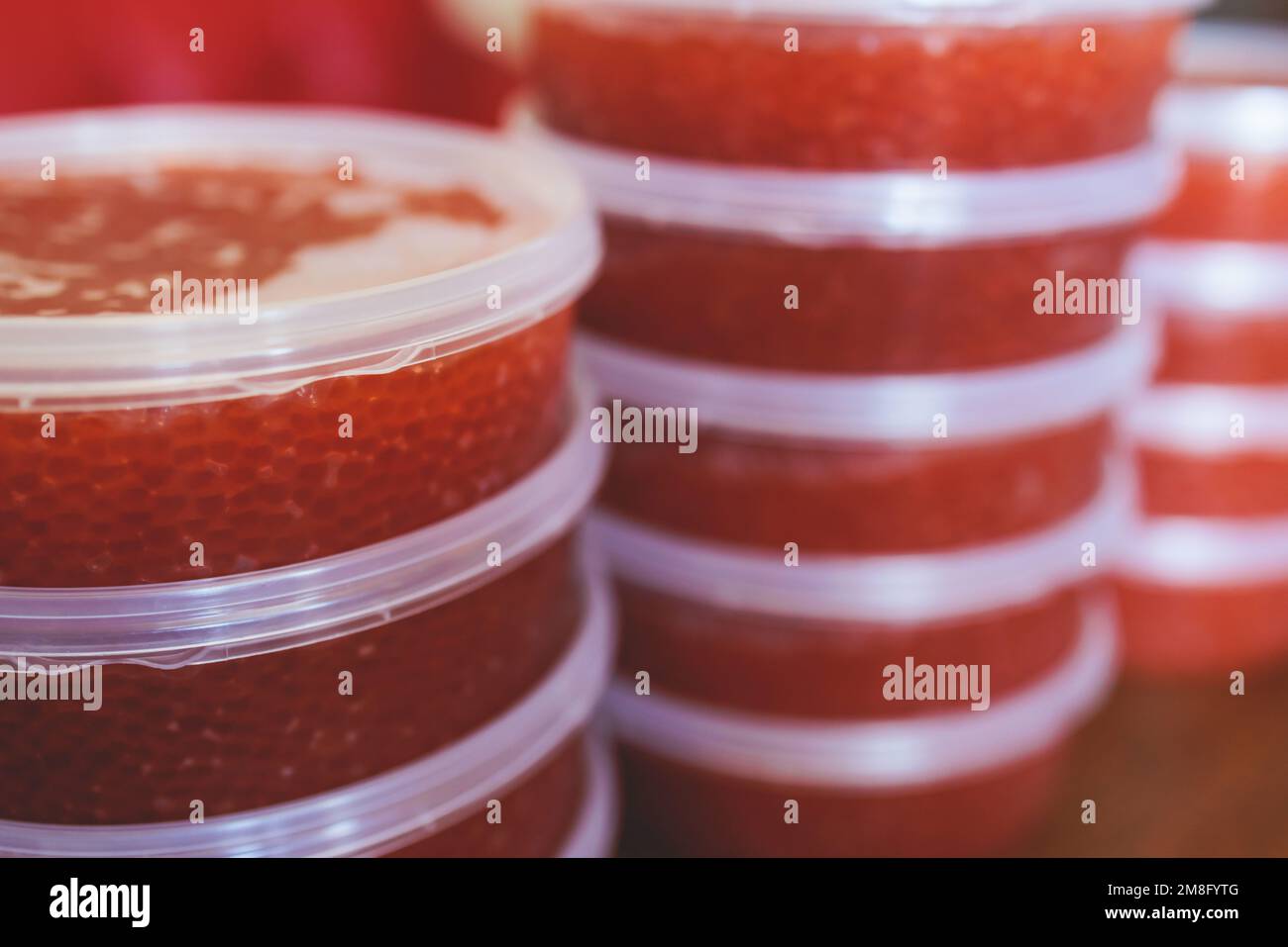 Red caviar plactic jars, rows of salted canned red caviar containers ...