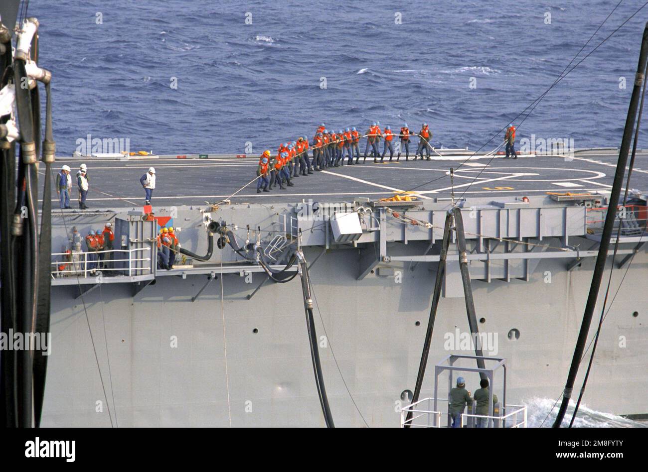 Sailors on the flight deck of the amphibious transport dock USS DUBUQUE ...