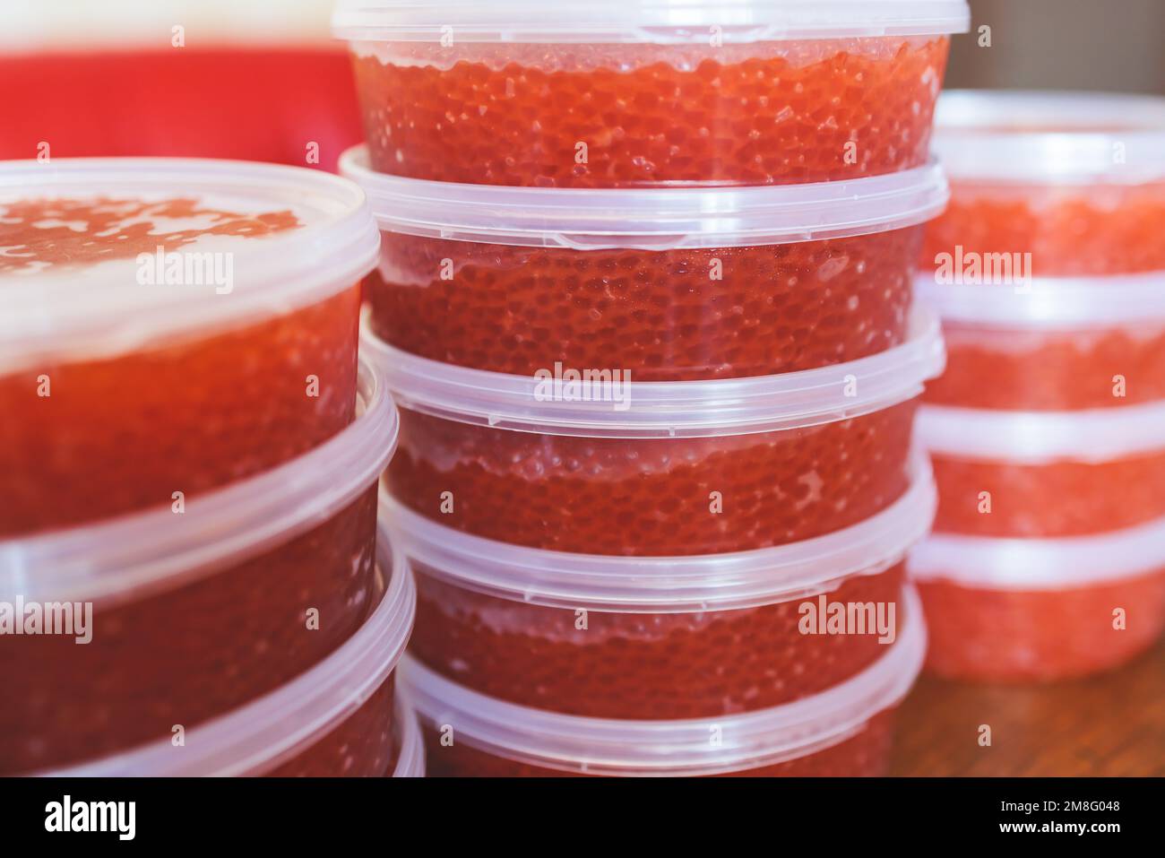 Red caviar plactic jars, rows of salted canned red caviar containers ...