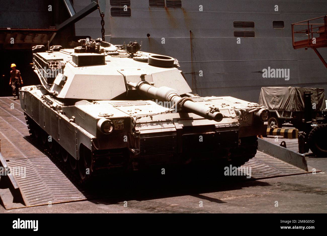 An M-1A1 Abrams main battle tank is driven aboard the rapid-response ...