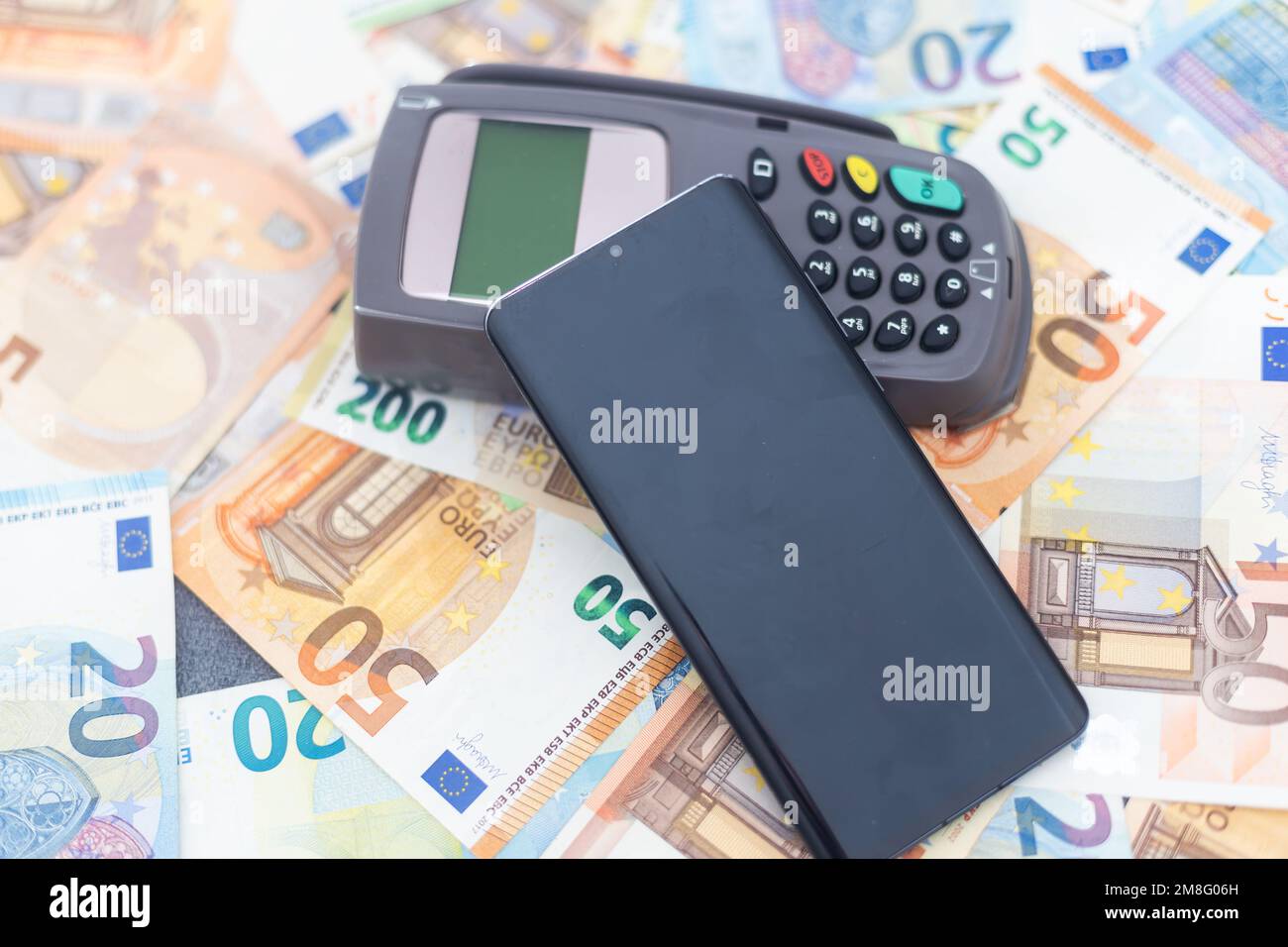 Banking terminal on euro banknotes background close up Stock Photo - Alamy