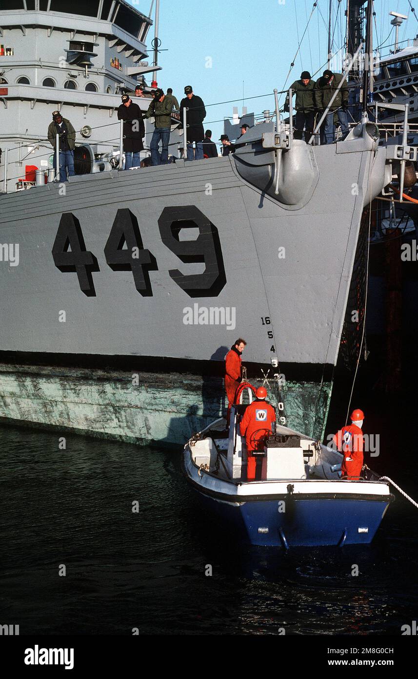 A work boat comes alongside the ocean minesweeper USS IMPERVIOUS (MSO ...
