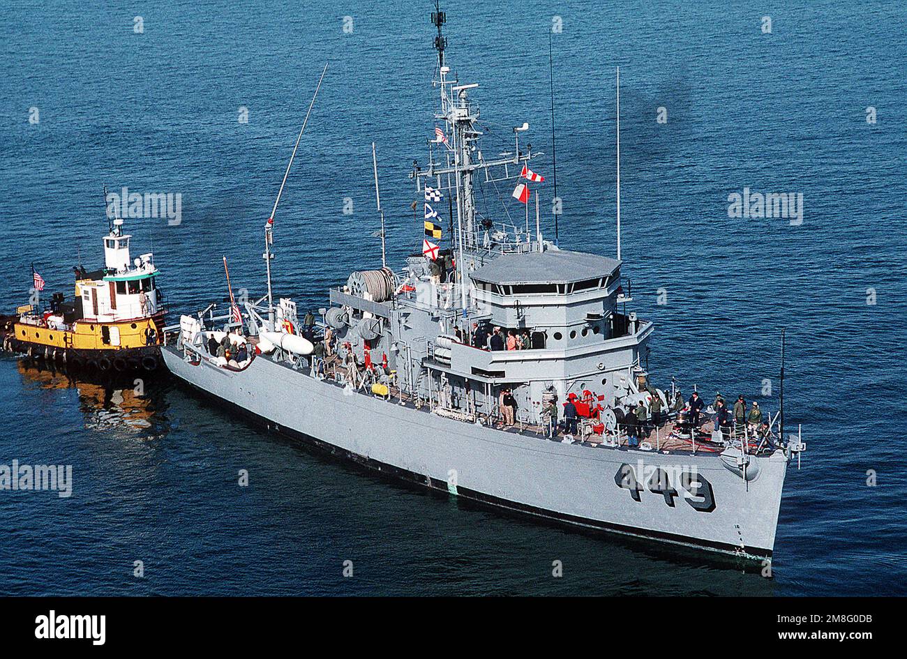 The ocean minesweeper USS IMPERVIOUS (MSO-449) is moved to the pier ...