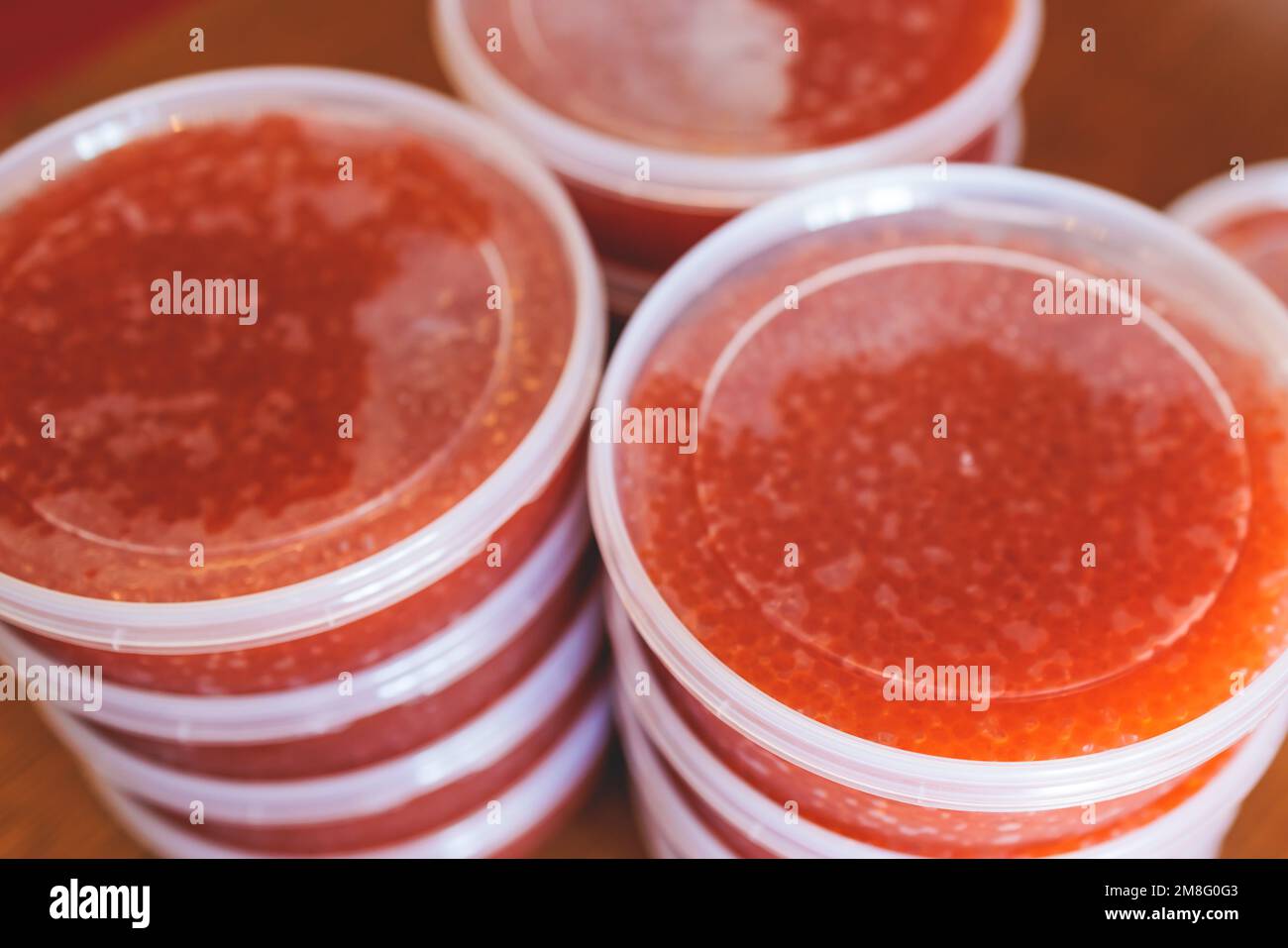 Red caviar plactic jars, rows of salted canned red caviar containers ...