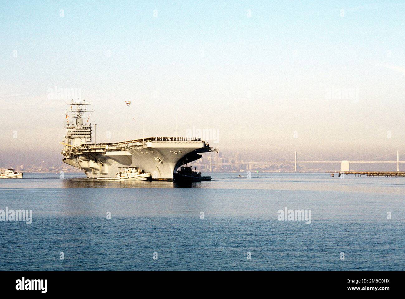 The crew of the nuclear-powered aircraft carrier USS ABRAHAM LINCOLN ...