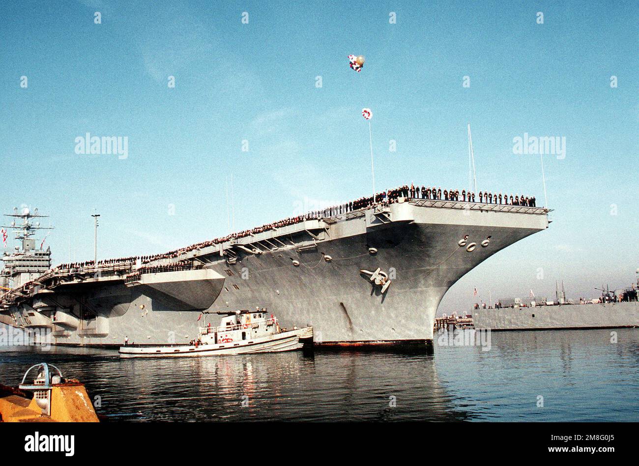 Crew members aboard the nuclear-powered aircraft carrier USS ABRAHAM ...