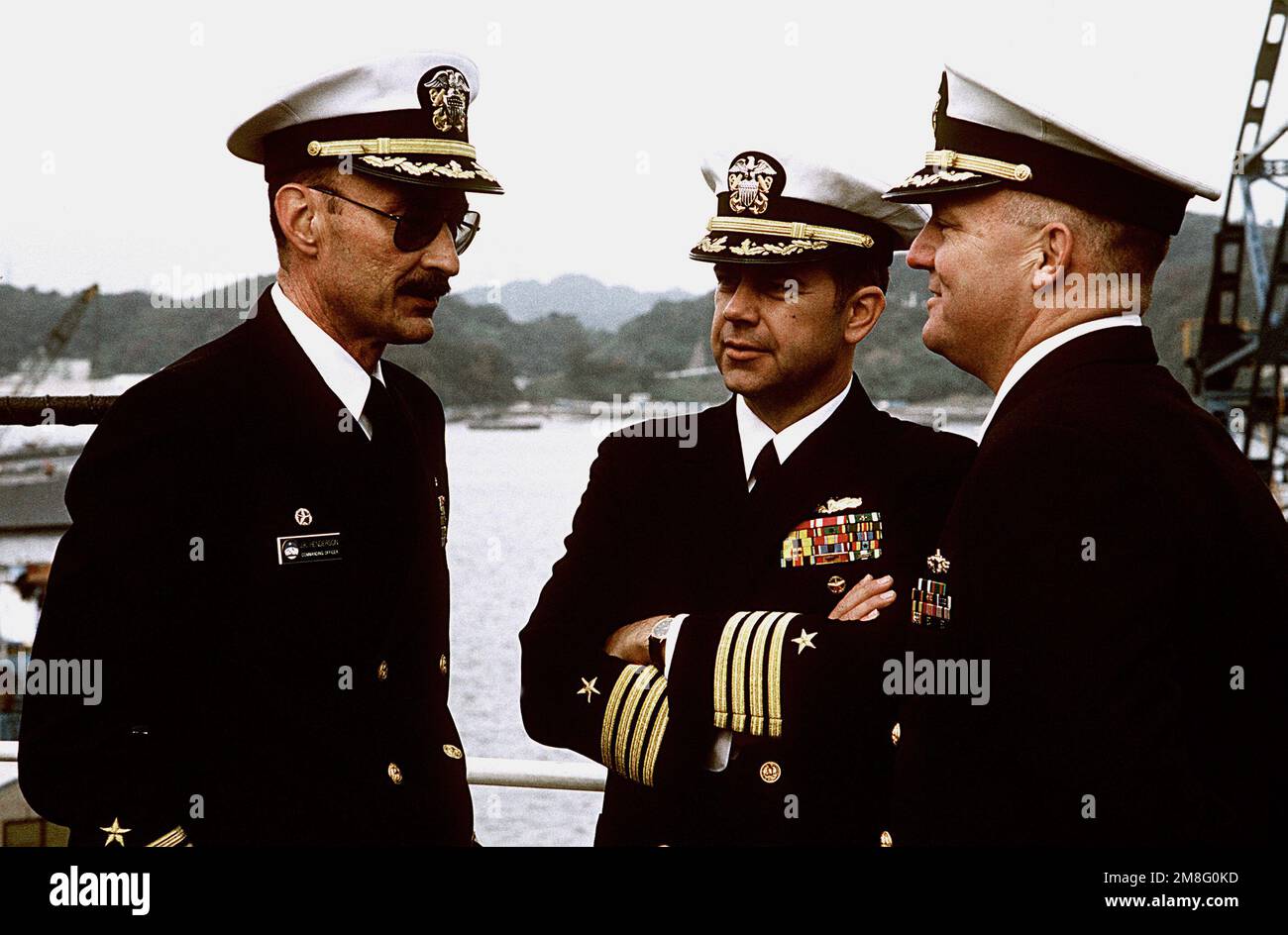 CAPT Joseph Kee Henderson converses with CAPT Alan L. Heisig and ...