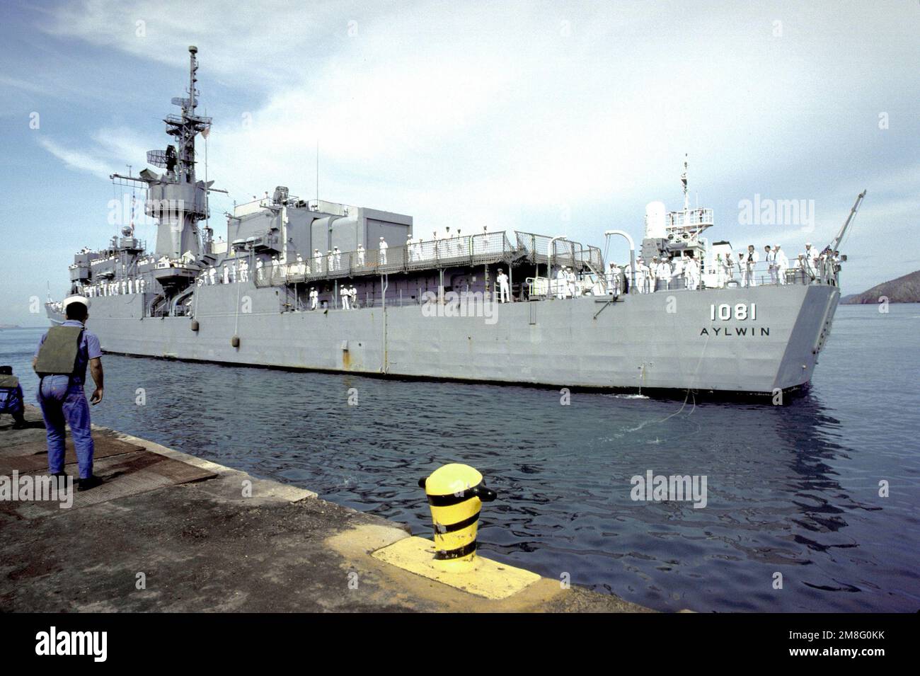 Line handlers on the pier pick up a messenger line thrown from the ...