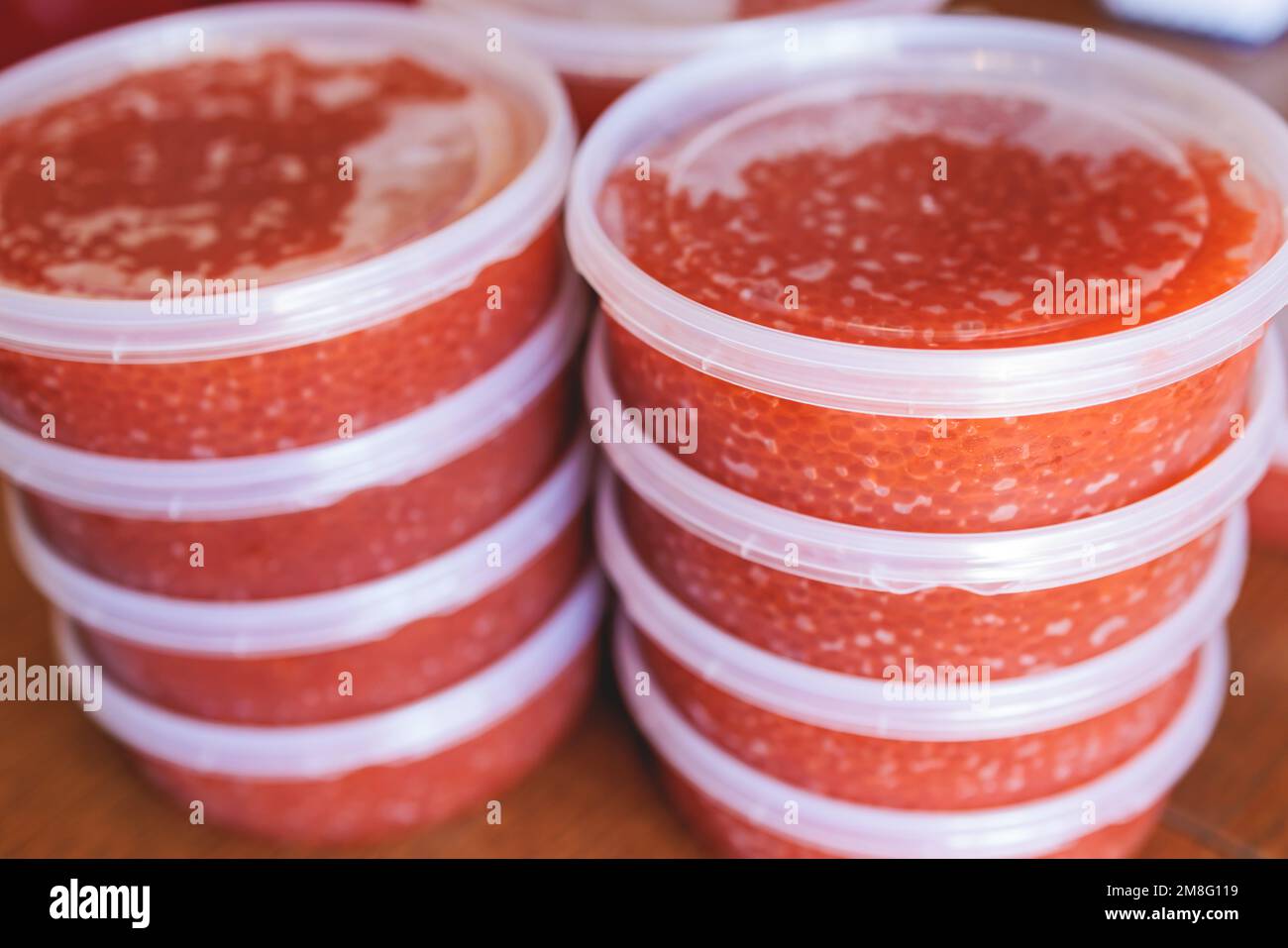 Red caviar plactic jars, rows of salted canned red caviar containers ...