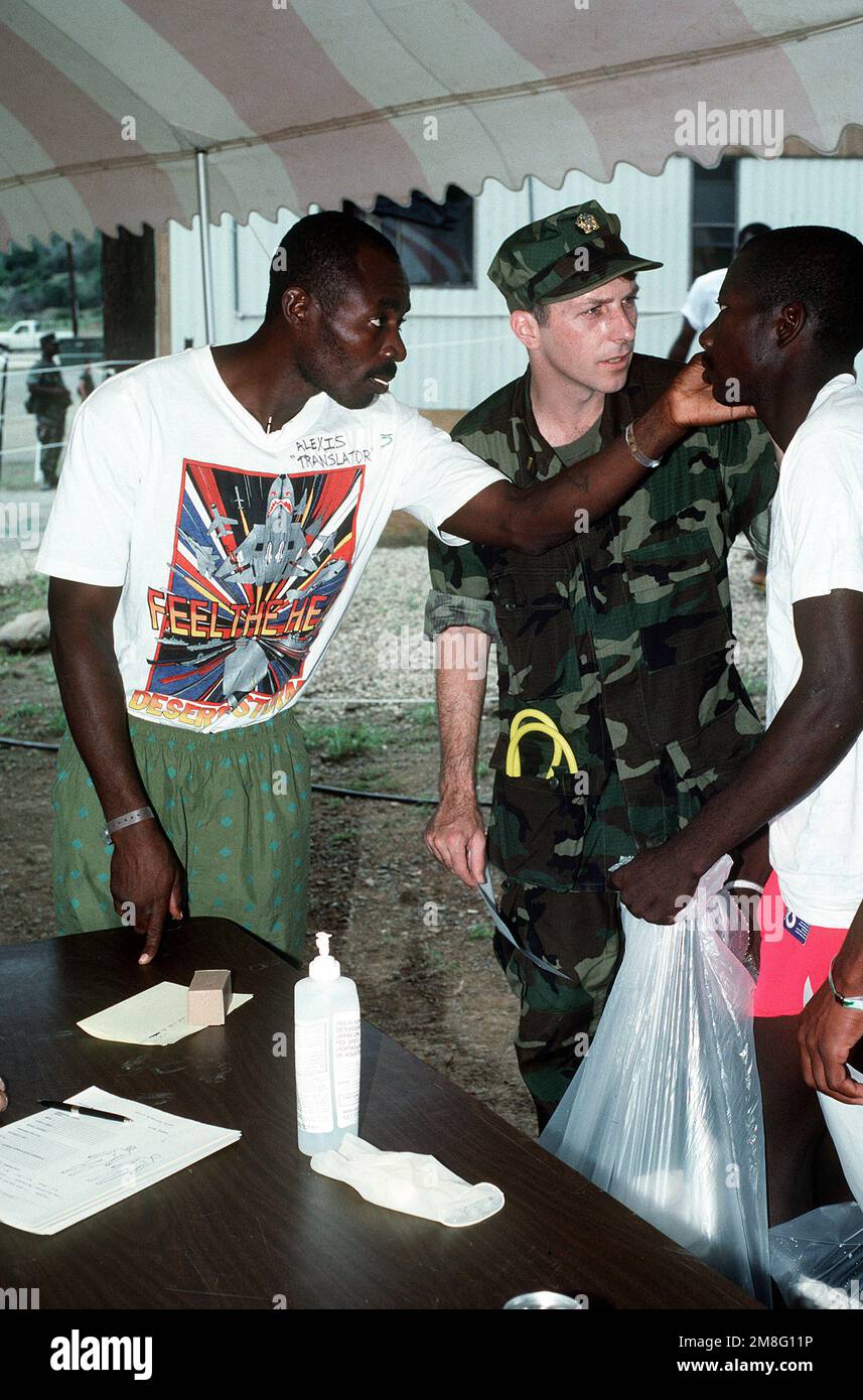 A Haitian refugee receives medical assistance at Camp McCalla, site of ...