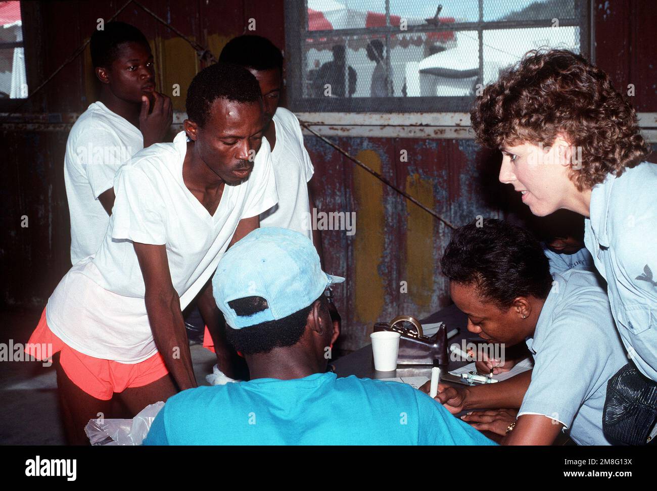 U.S. military personnel process paperwork for Haitian refugees at Camp ...