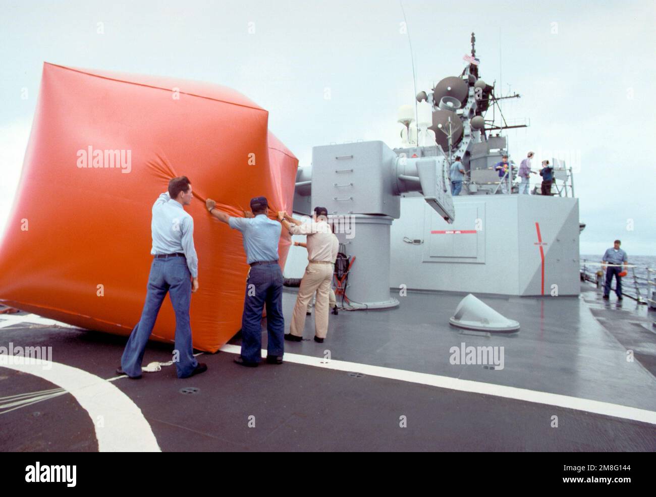 Sailors on the flight deck of the guided missiled destroyer USS ...