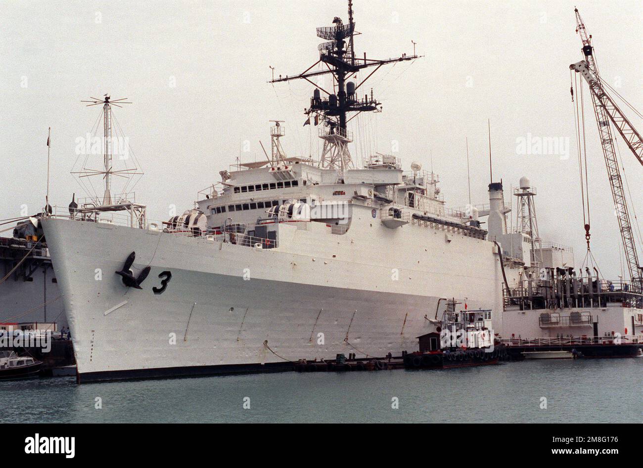 A port bow view of the miscellaneous flagship USS LA SALLE (AGF-3) docked in port. The LA SALLE ...